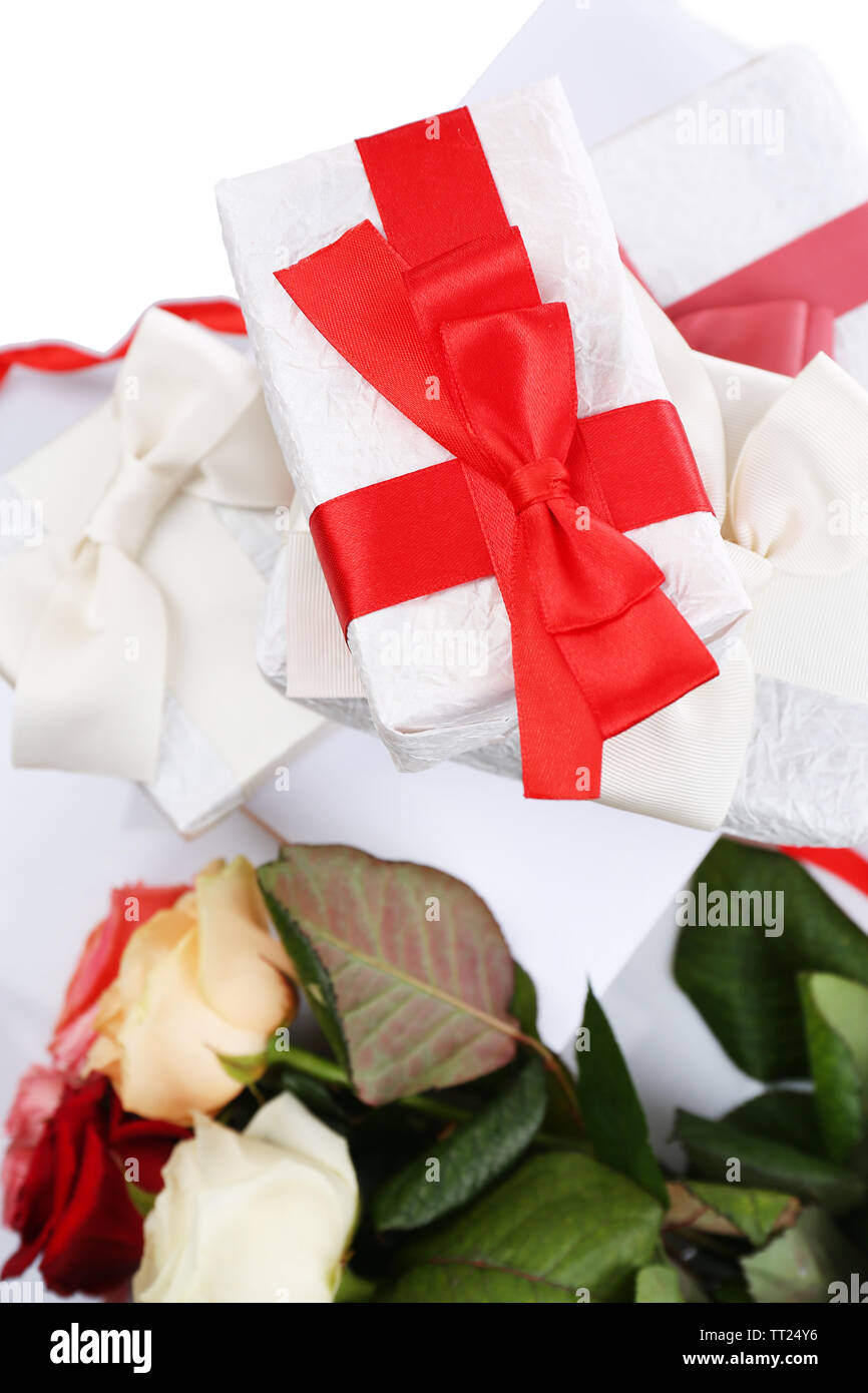 Beautiful gifts with red ribbons and flowers, close up Stock Photo - Alamy
