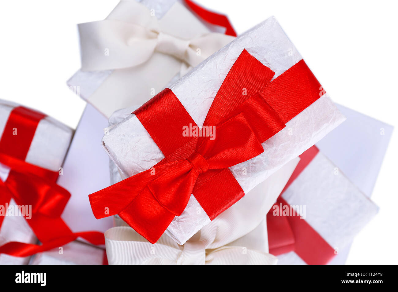 Beautiful gifts with red ribbons, close up Stock Photo - Alamy