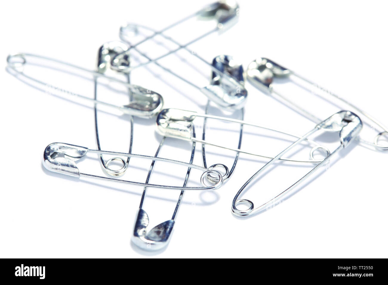 Safety pins isolated on white Stock Photo - Alamy