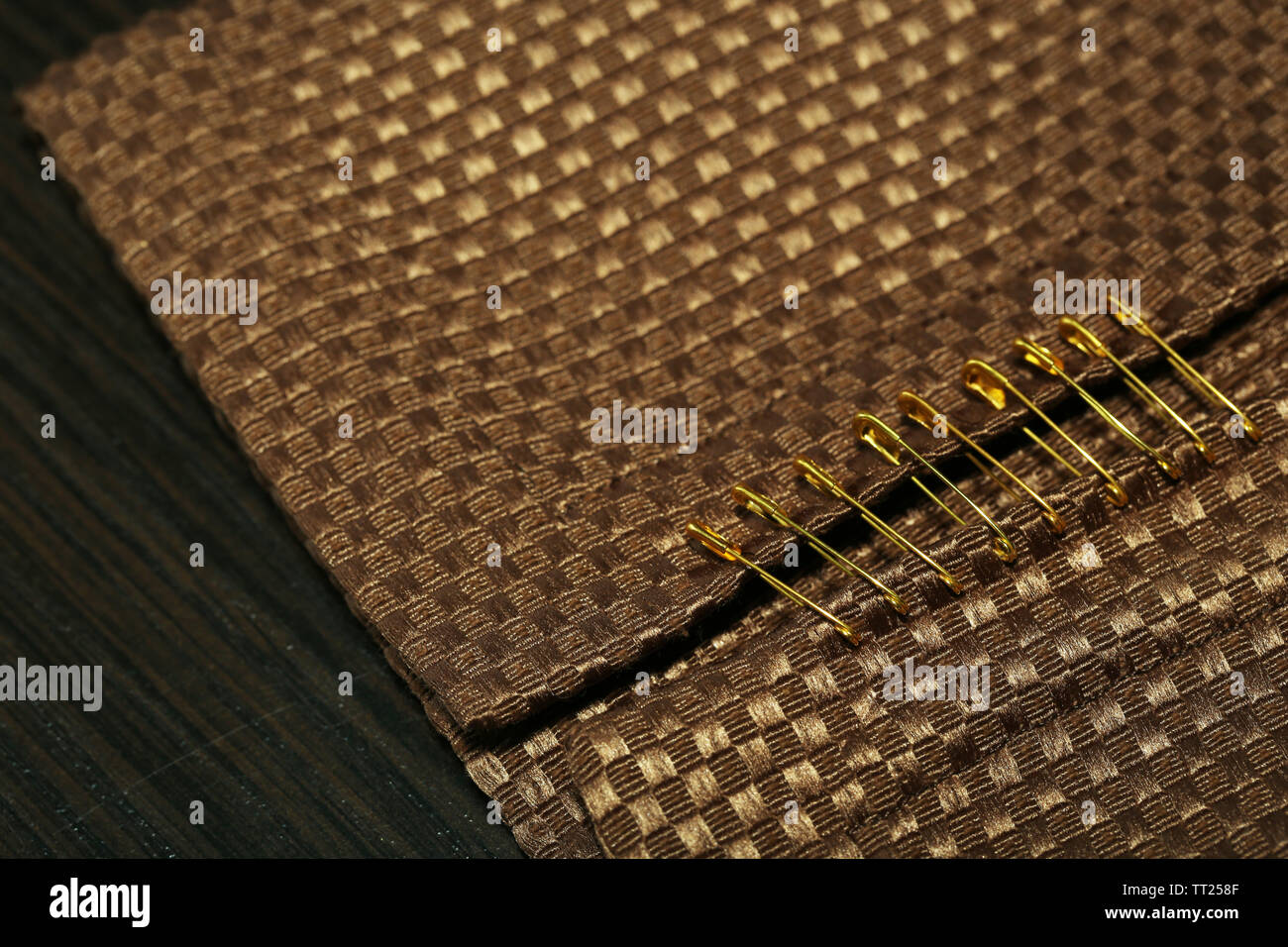 Safety pins on fabric background Stock Photo - Alamy