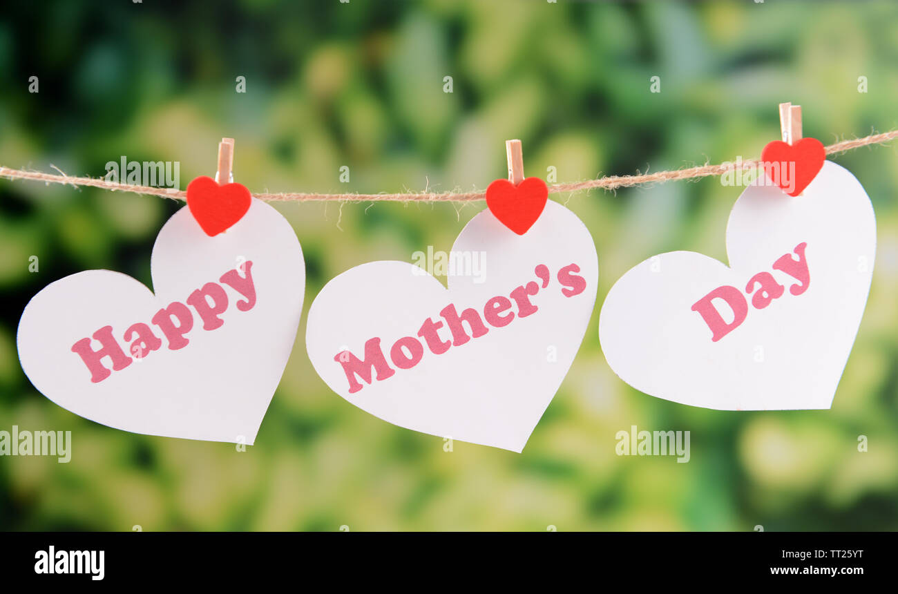 Happy Mothers Day message written on paper hearts with flowers on ...