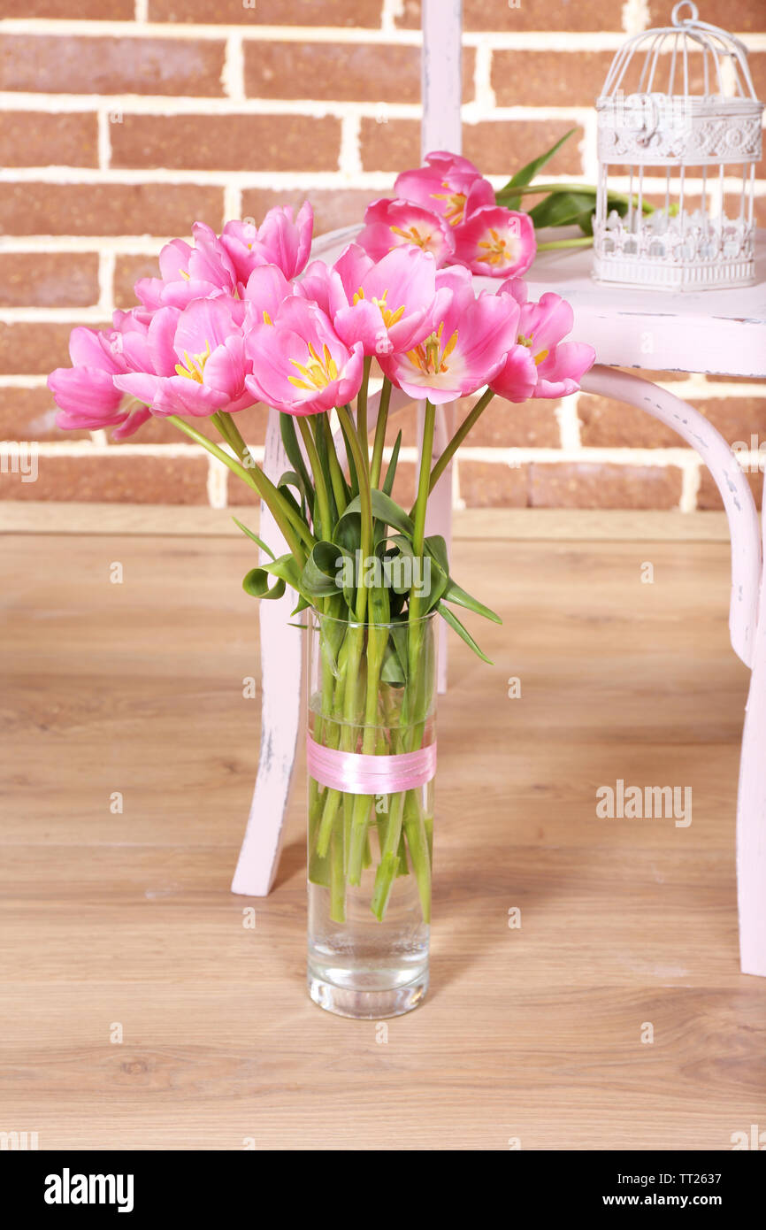 Beautiful pink tulips on brick wall background Stock Photo - Alamy