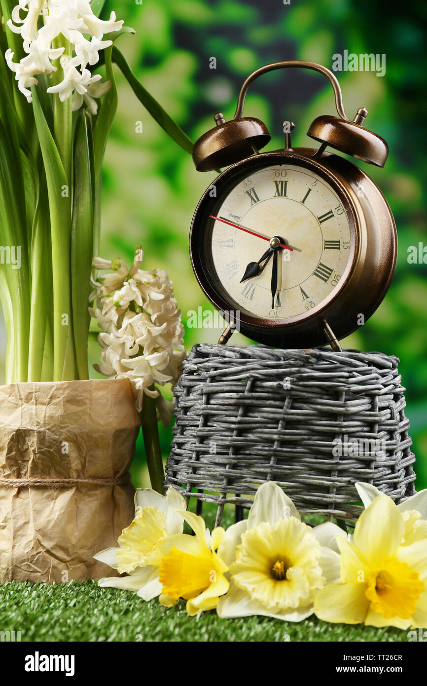 Alarm clock on green grass, on nature background Stock Photo - Alamy