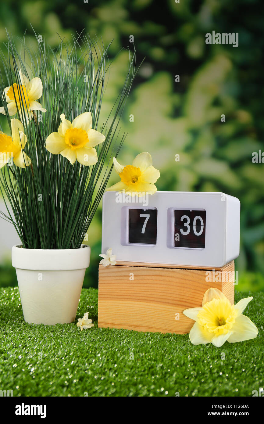 Alarm clock on green grass, on nature background Stock Photo - Alamy