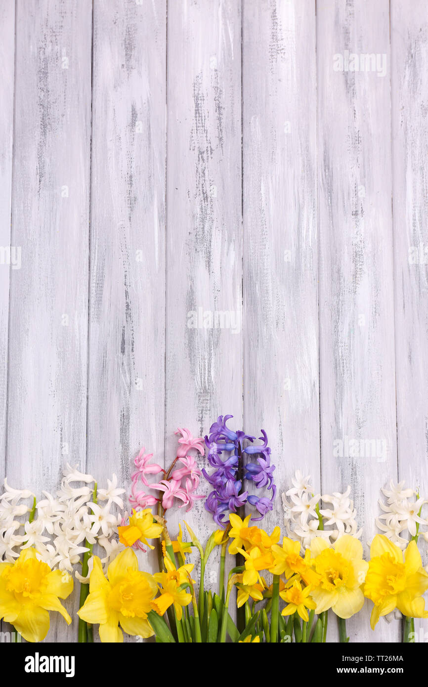 Beautiful flowers on color wooden background Stock Photo - Alamy