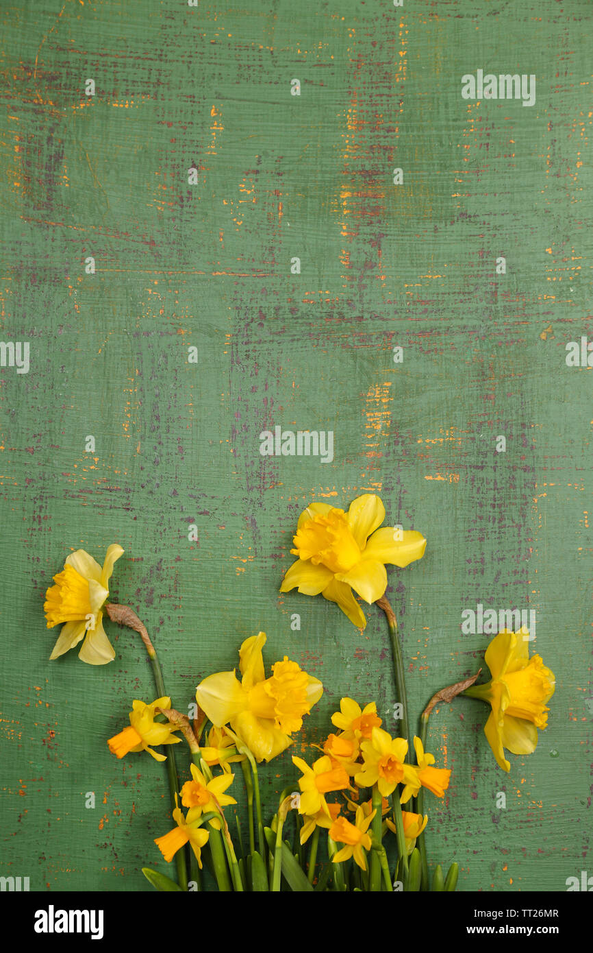 Beautiful flowers on color wooden background Stock Photo - Alamy