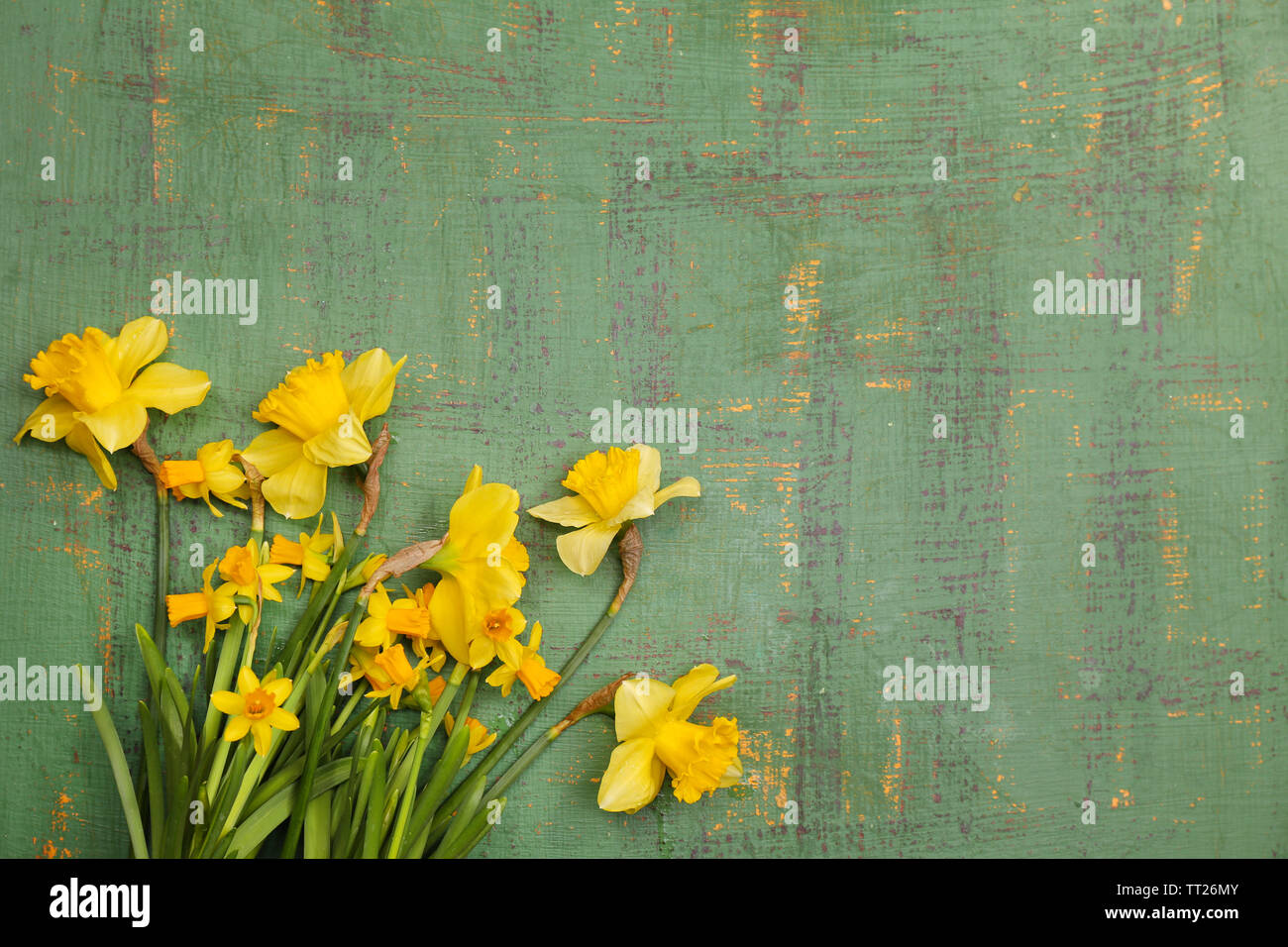 Beautiful flowers on color wooden background Stock Photo - Alamy