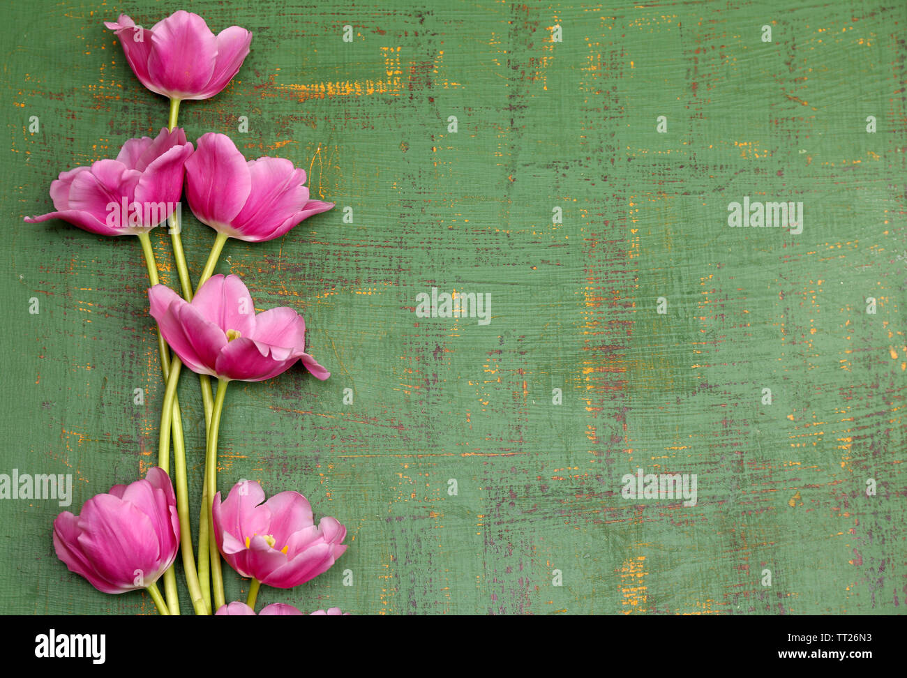 Beautiful flowers on color wooden background Stock Photo - Alamy