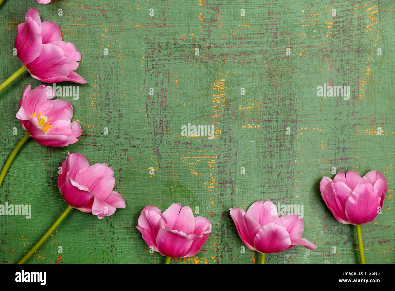 Beautiful flowers on color wooden background Stock Photo - Alamy