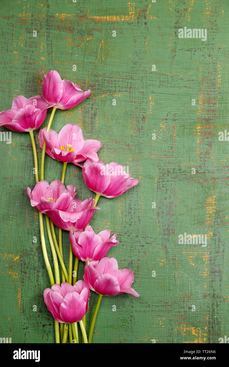 Beautiful flowers on color wooden background Stock Photo - Alamy