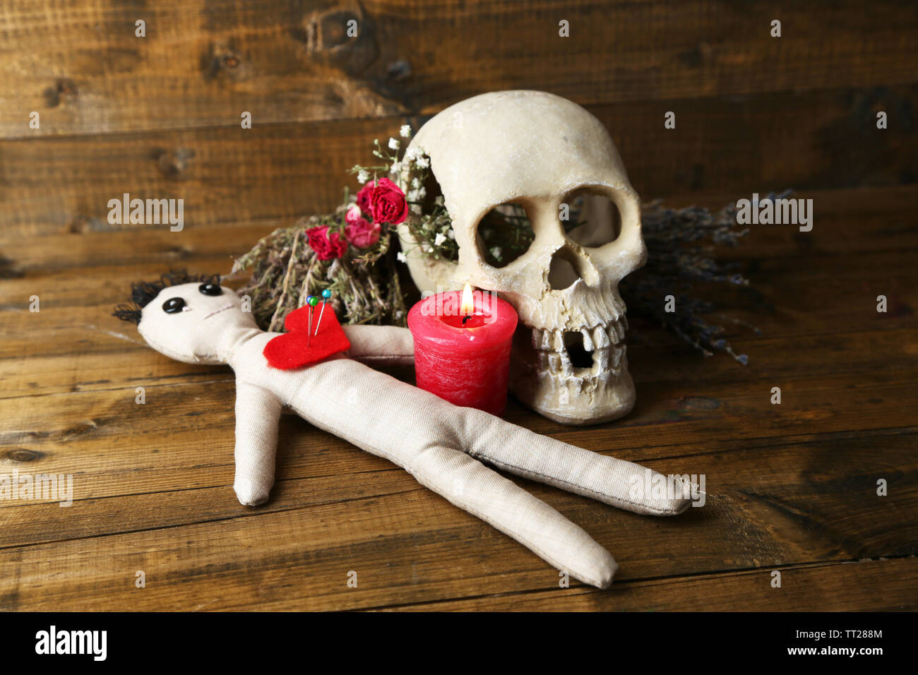 Conceptual photo of love magic. Composition with skull, voodoo doll ...