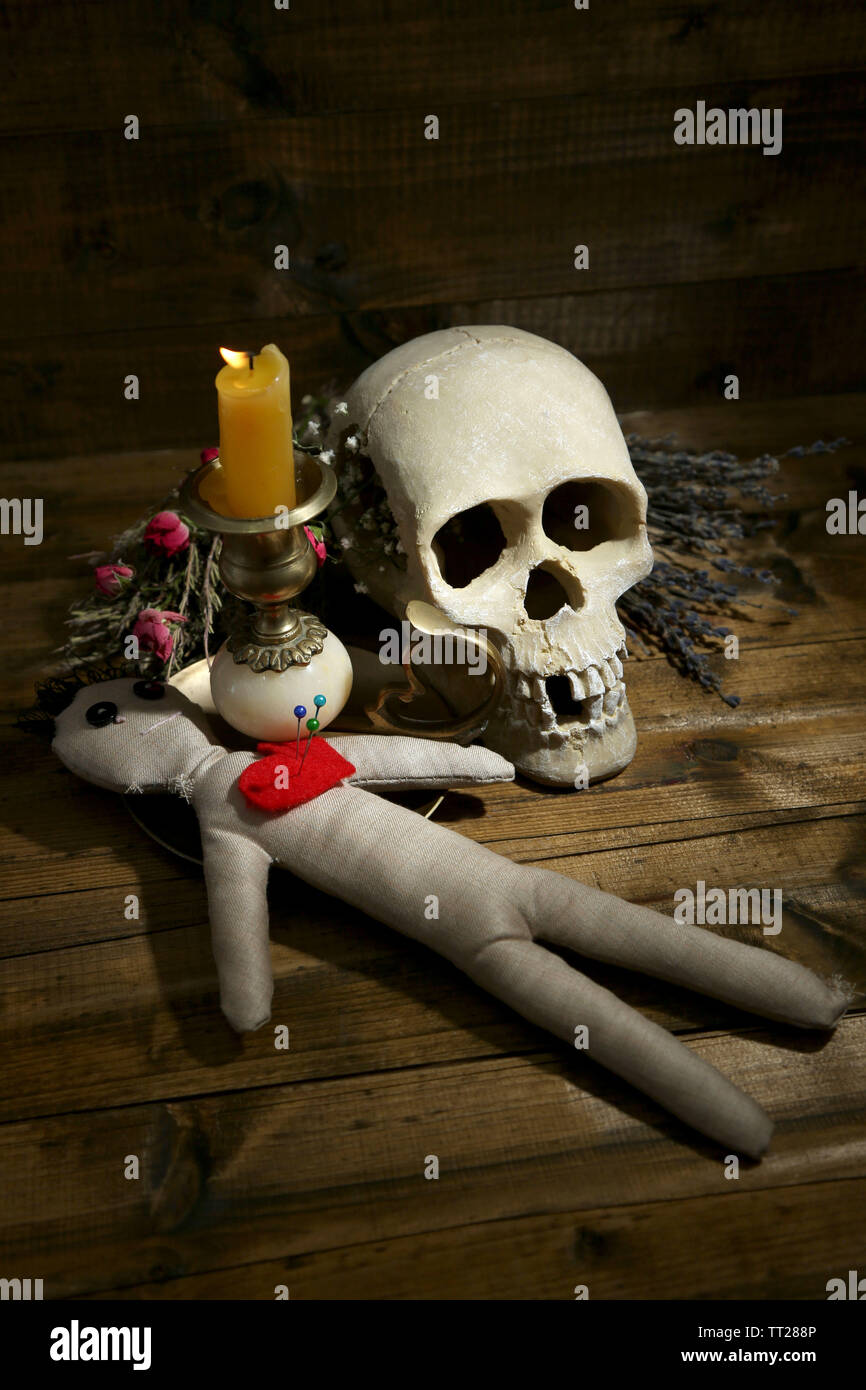 Conceptual photo of love magic. Composition with skull, voodoo doll ...
