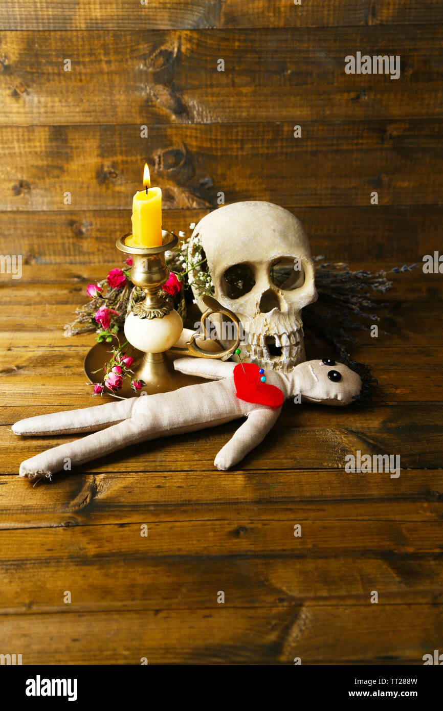 Conceptual photo of love magic. Composition with skull, voodoo doll ...