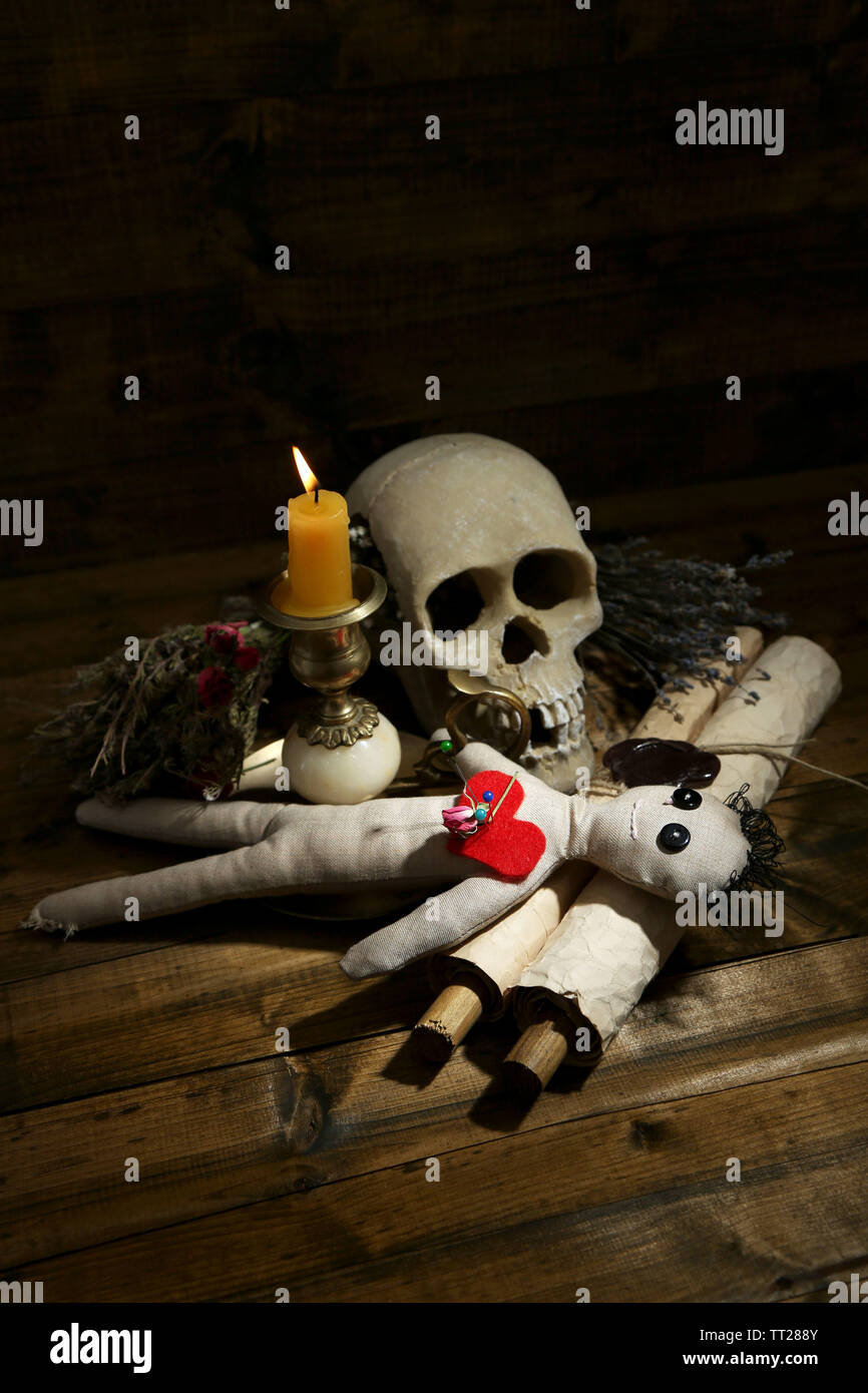 Conceptual photo of love magic. Composition with skull, voodoo doll ...