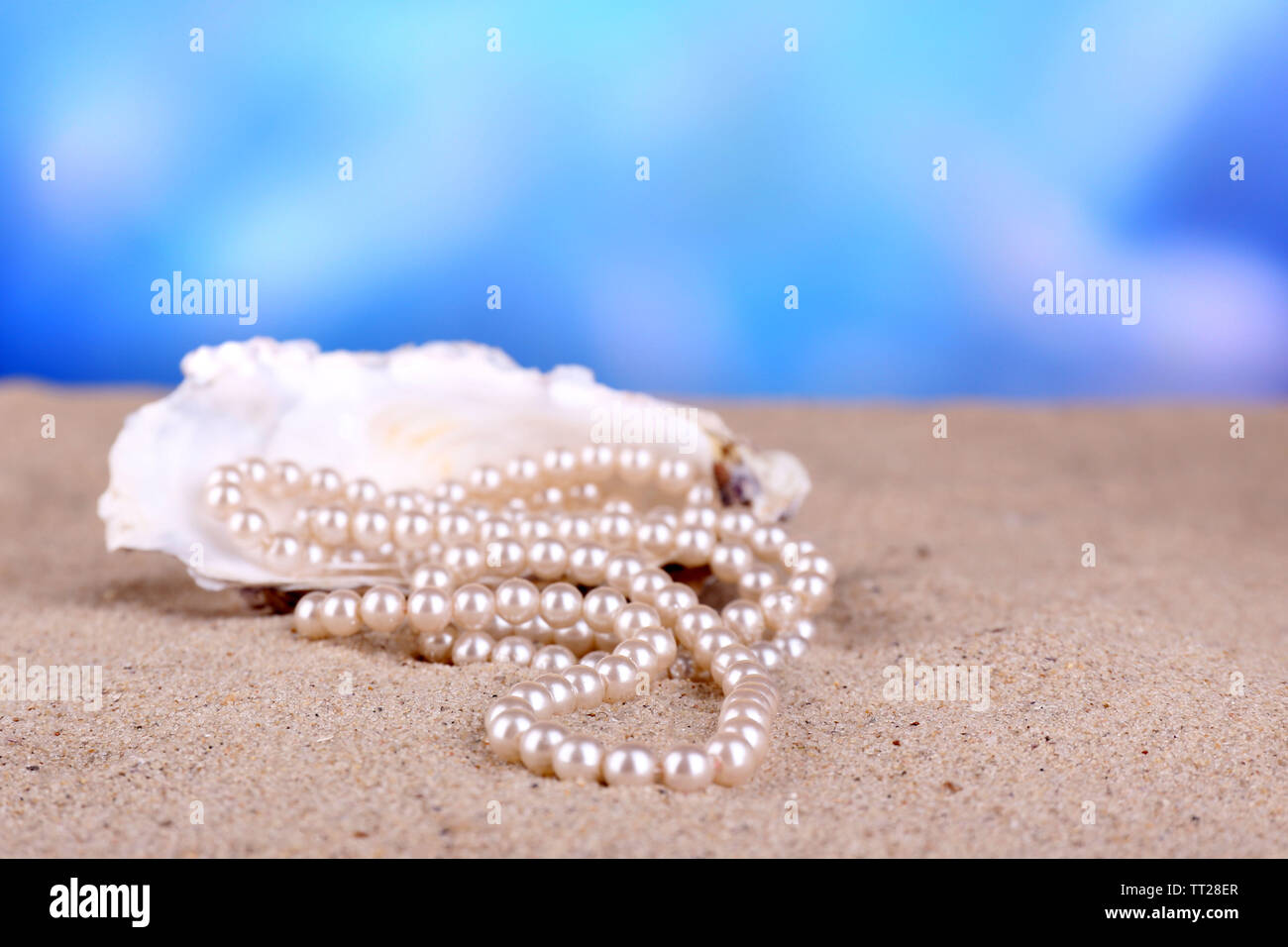 Beautiful pearls in shell on sand, close up Stock Photo - Alamy