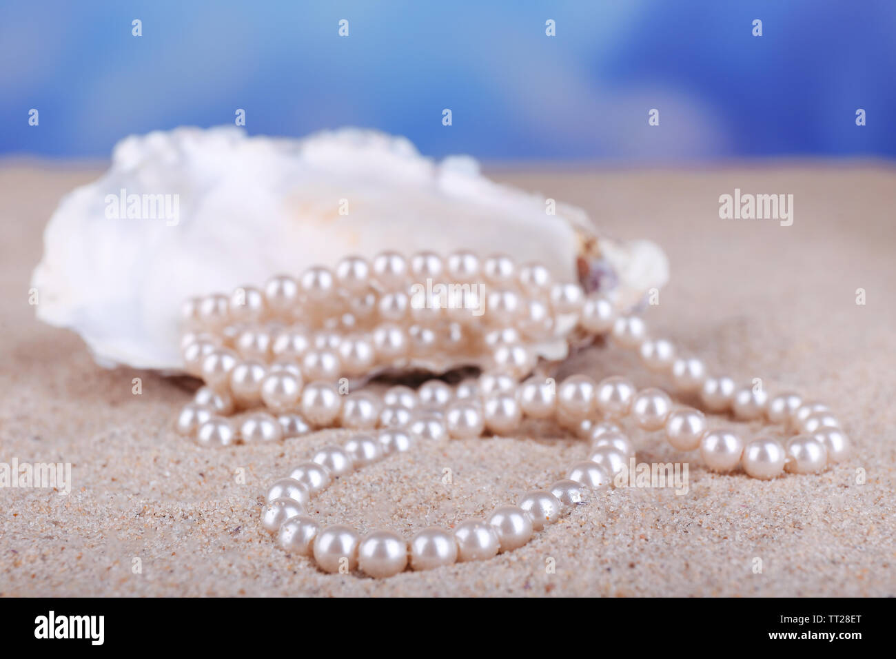 Beautiful pearls in shell on sand, close up Stock Photo - Alamy
