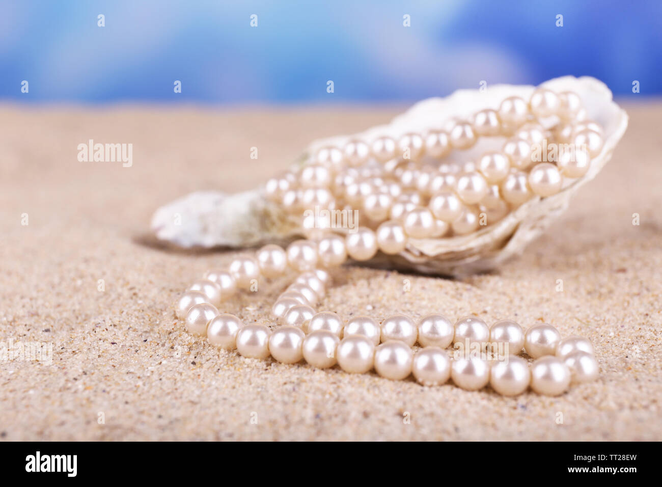 Beautiful pearls in shell on sand, close up Stock Photo - Alamy