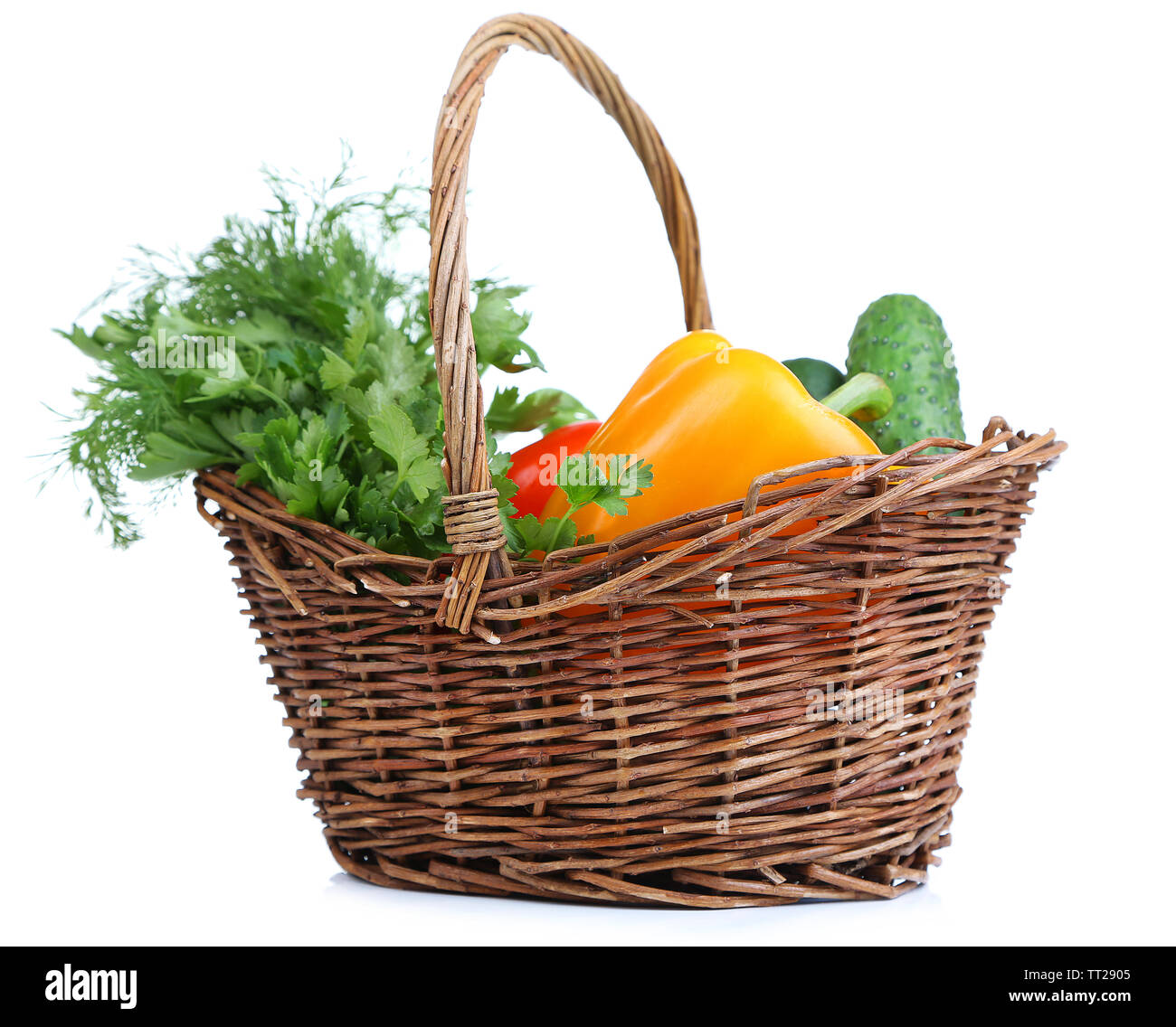 Composition with raw vegetables in wicker basket isolated on white ...