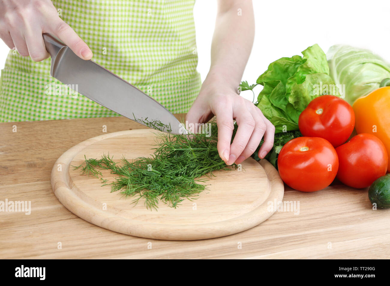 Female hands chopping dill on wooden board, close-up, isolated on white ...