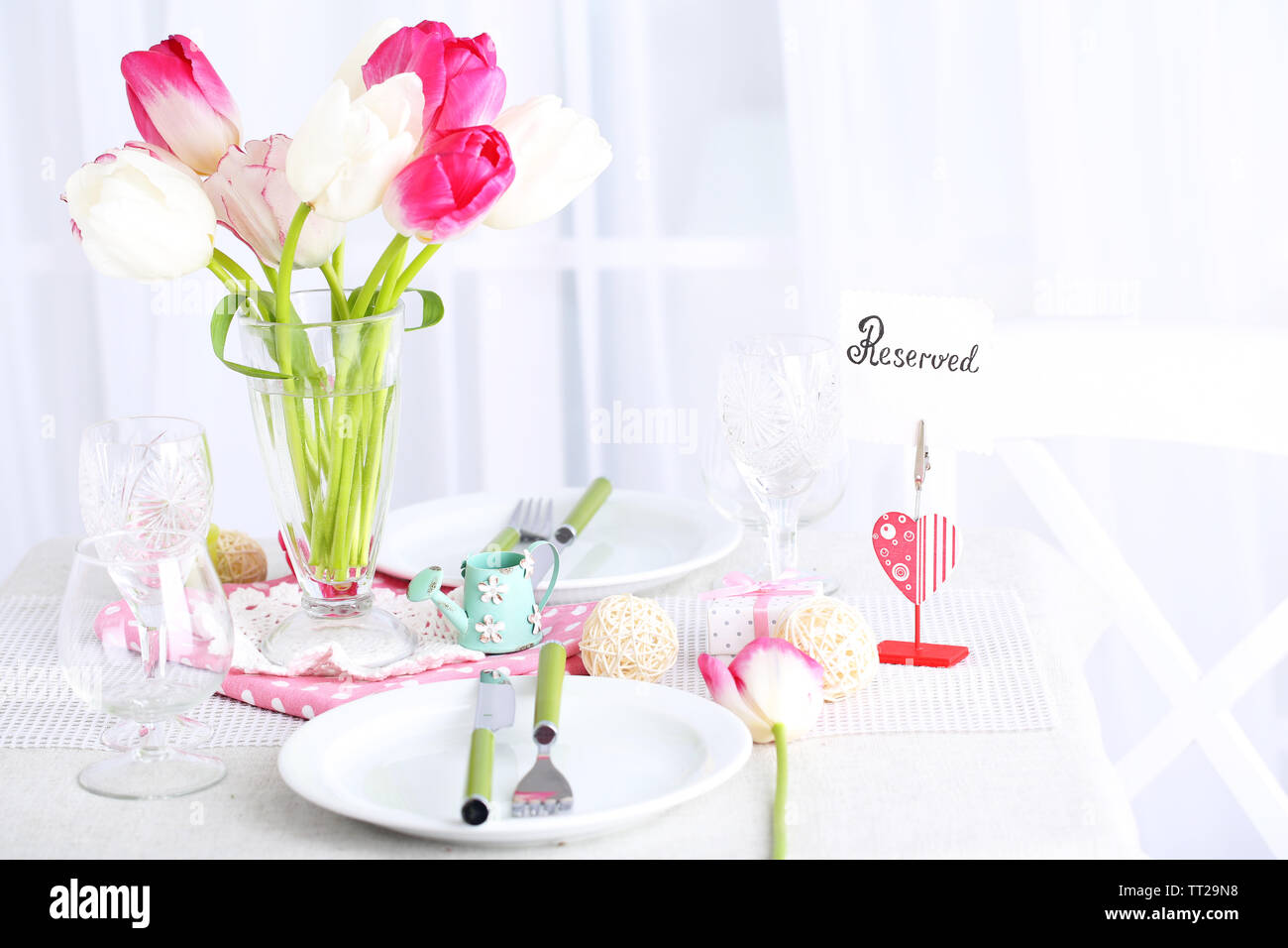 Beautiful spring table setting on light background Stock Photo - Alamy