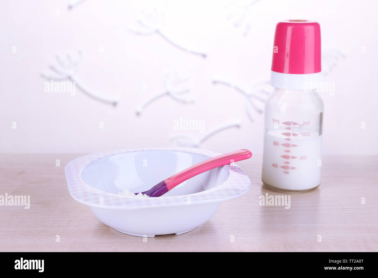 Baby food and milk on table on light background Stock Photo - Alamy
