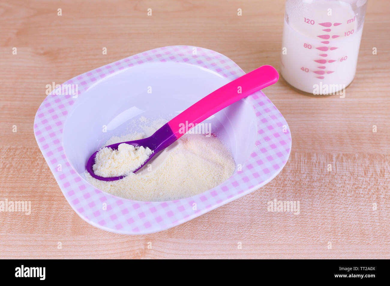 Baby food and milk on wooden table Stock Photo - Alamy