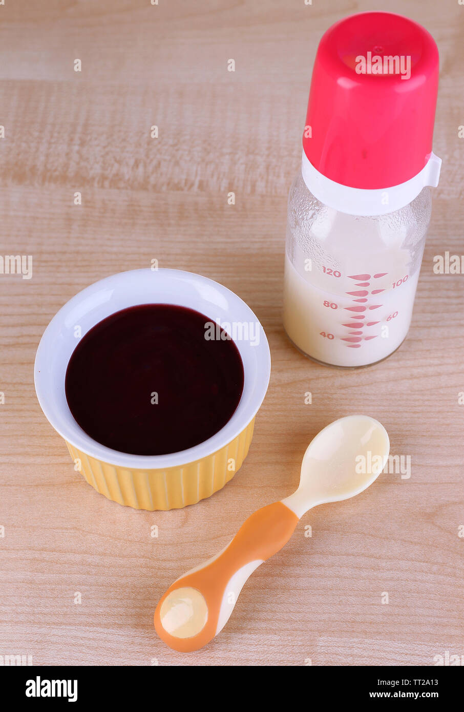 Baby food and milk on wooden table Stock Photo - Alamy