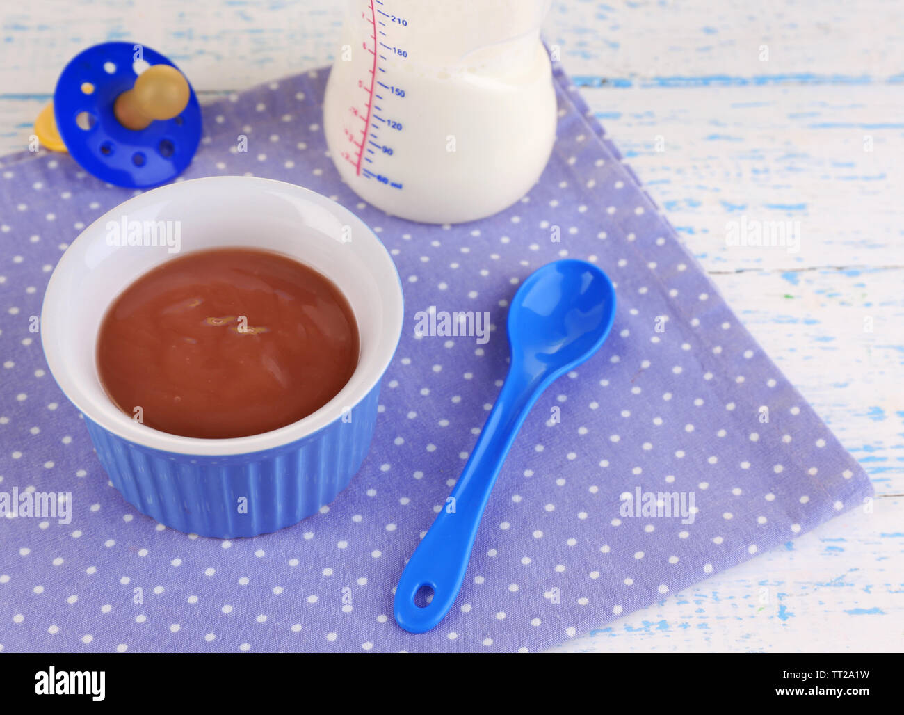 Baby food and milk on wooden table Stock Photo - Alamy