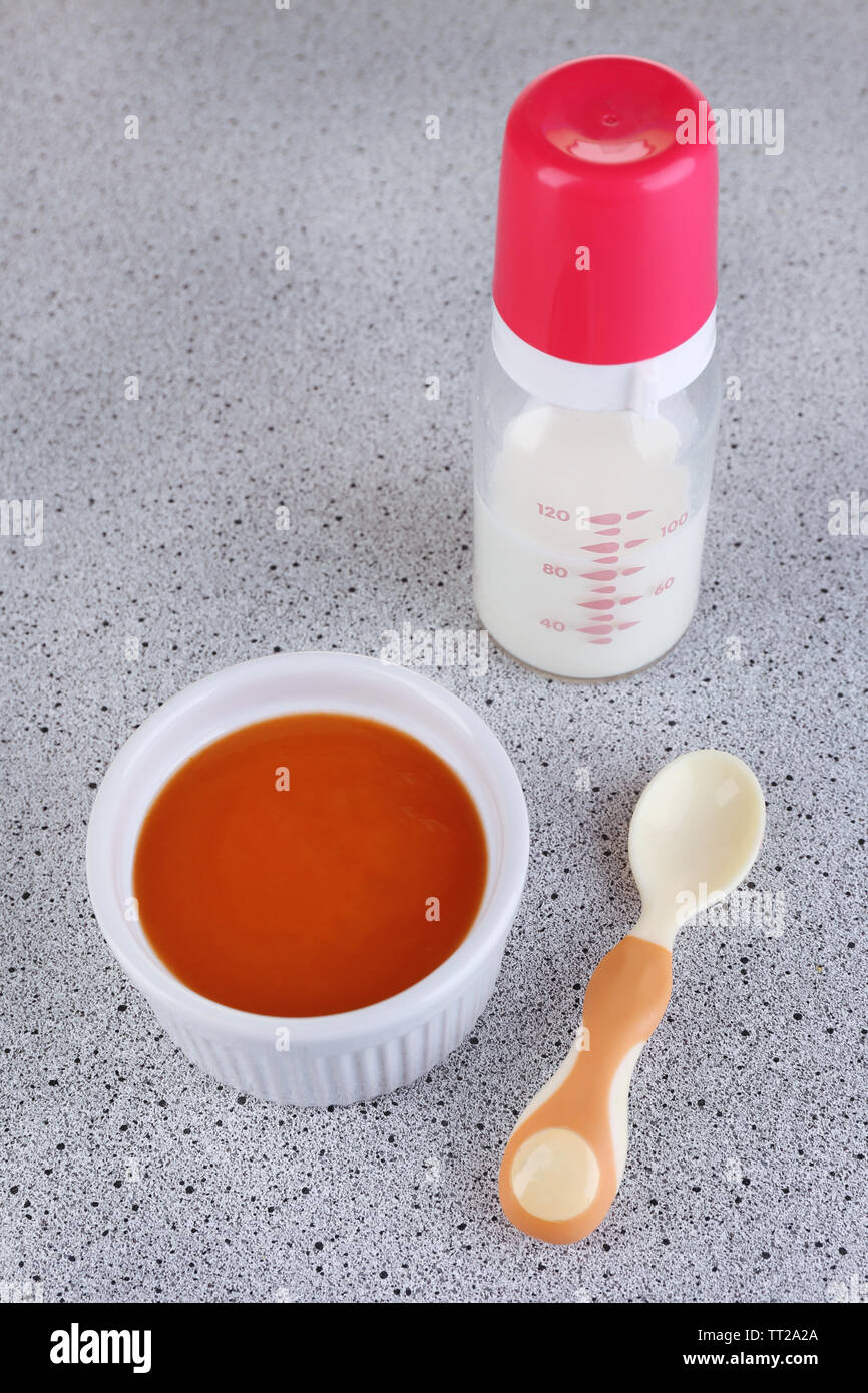 Baby food and milk on table close up Stock Photo - Alamy