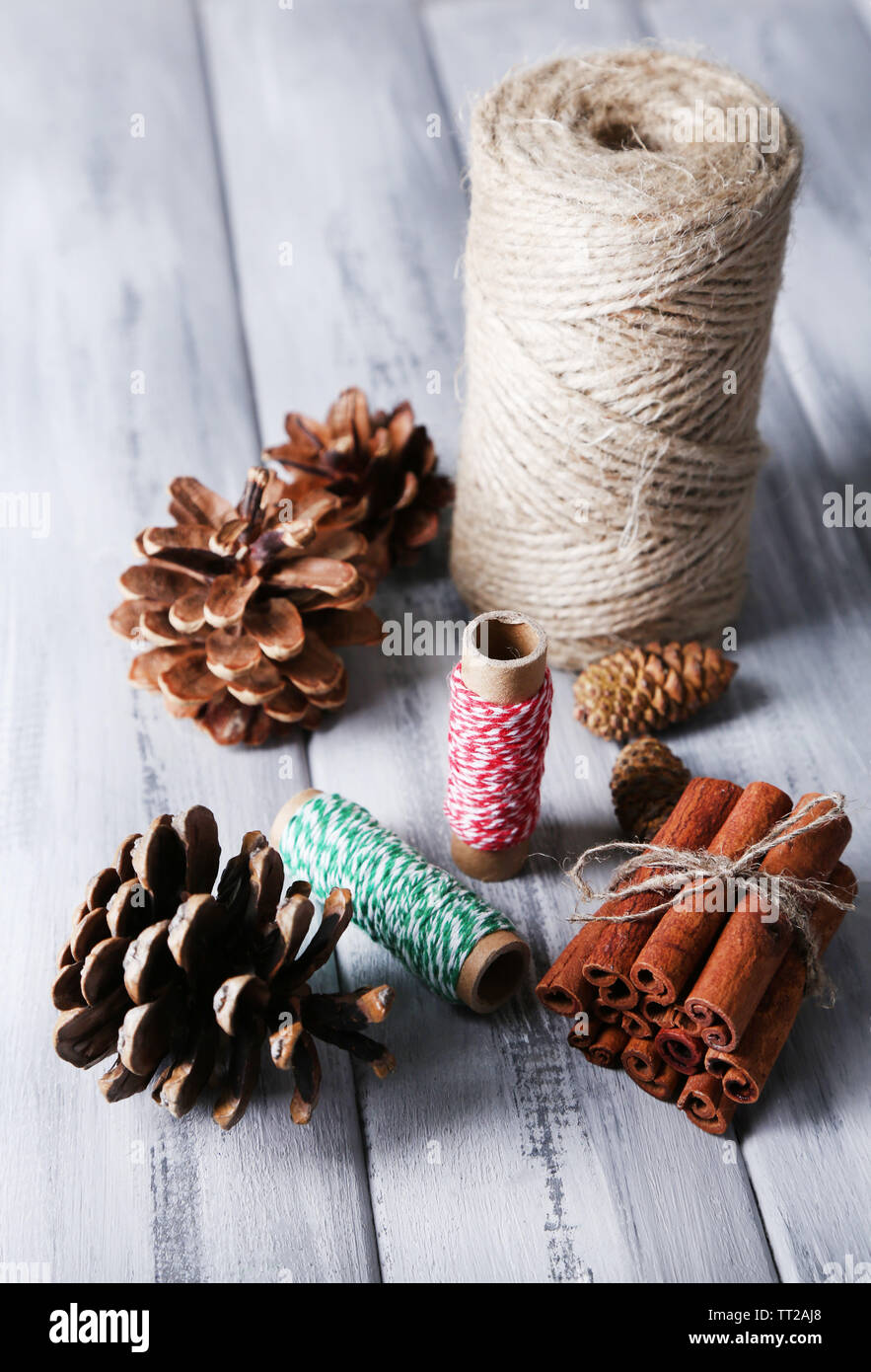 Composition with natural bump, thread, cinnamon sticks on wooden ...