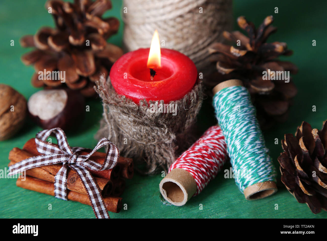 Composition with natural bump, candle, thread, cinnamon sticks on ...