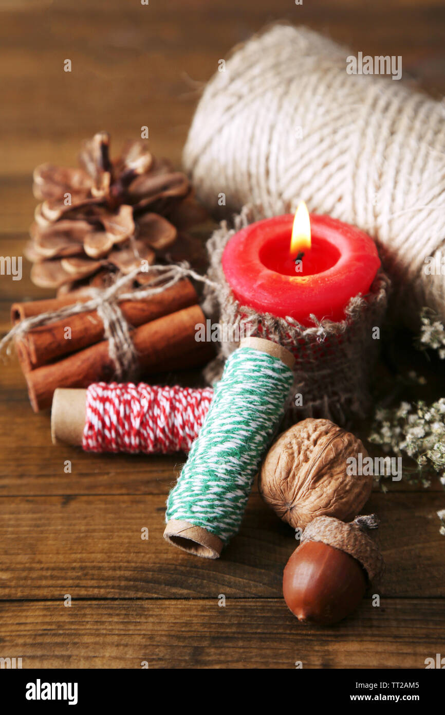 Composition with natural bump, candle, thread, cinnamon sticks on ...