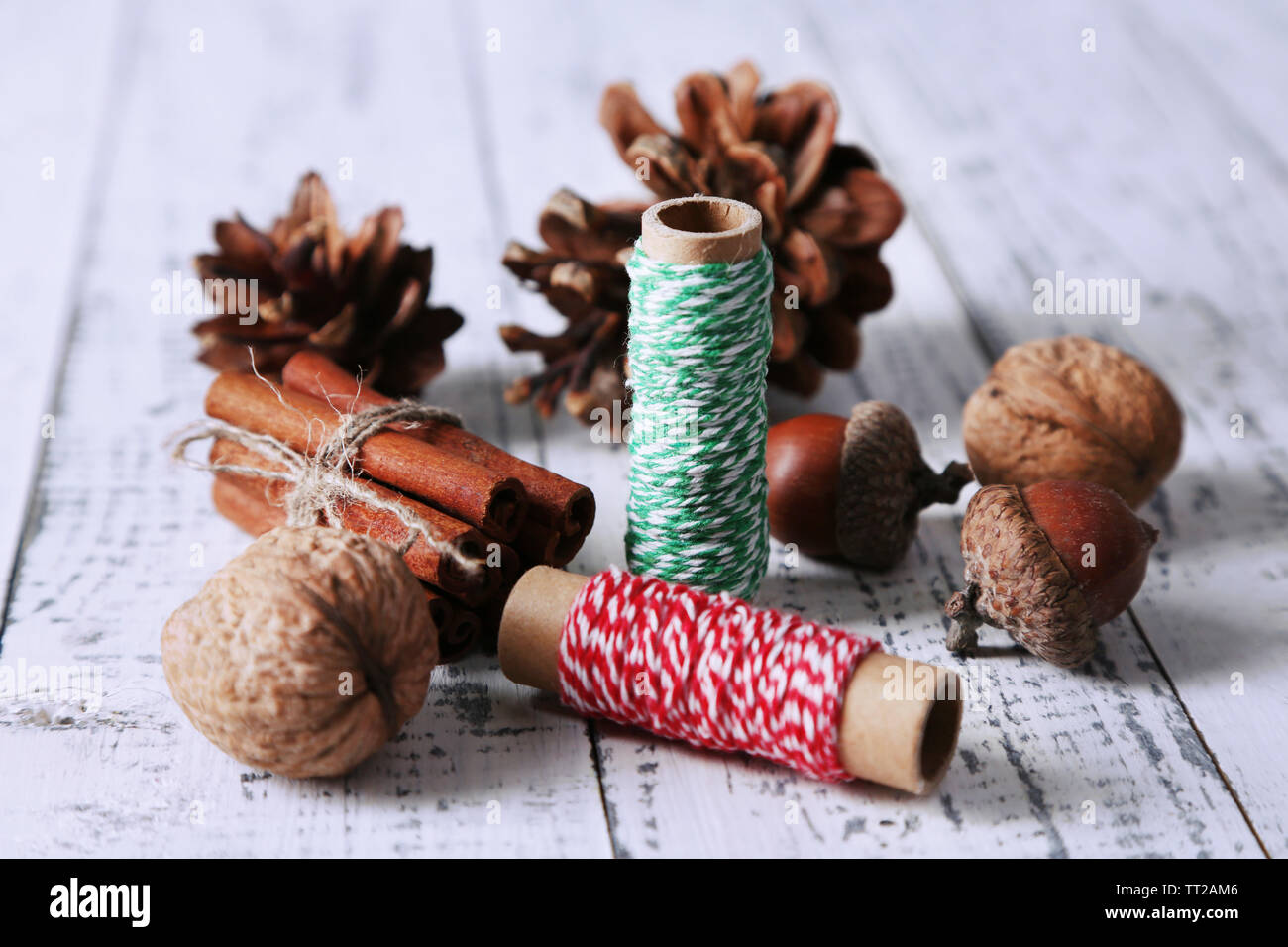 Composition with natural bump, thread, cinnamon sticks on wooden ...