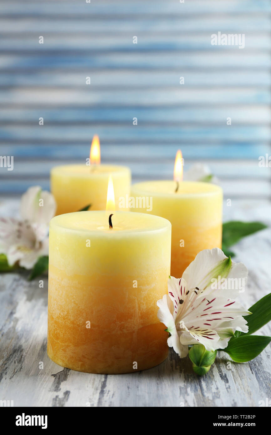 Beautiful candles with flowers on wooden background Stock Photo - Alamy