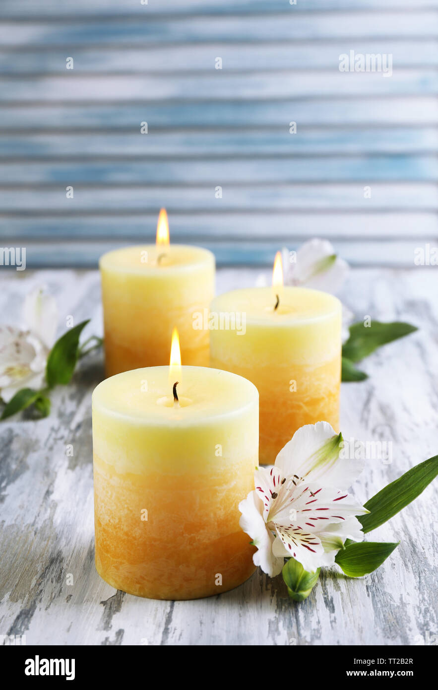 Beautiful candles with flowers on wooden background Stock Photo - Alamy