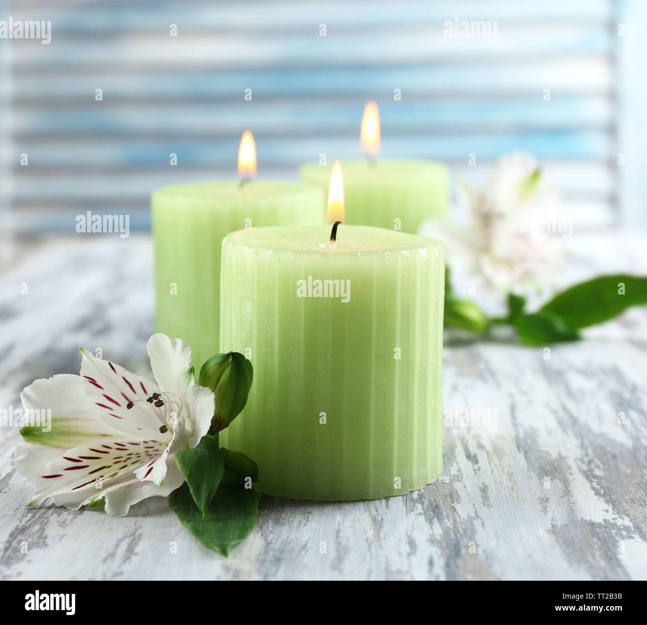 Beautiful candles with flowers on wooden background Stock Photo - Alamy