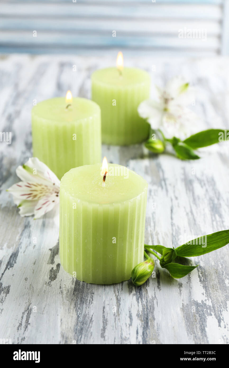 Beautiful candles with flowers on wooden background Stock Photo - Alamy