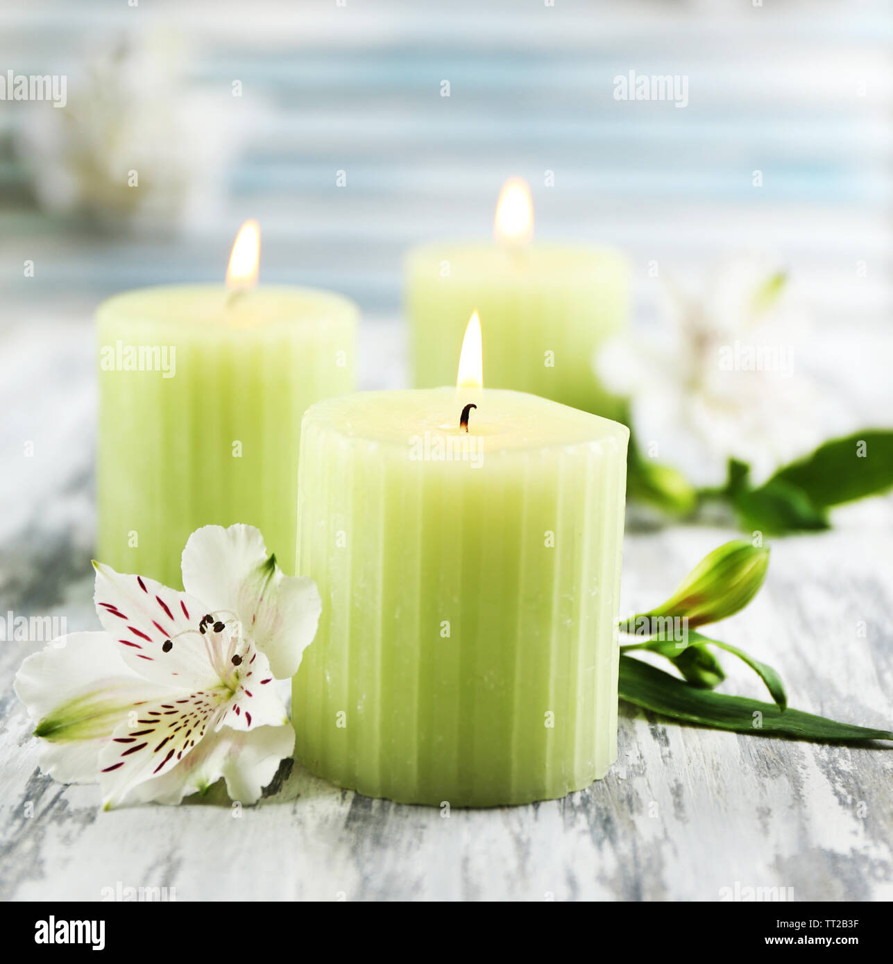 Beautiful candles with flowers on wooden background Stock Photo - Alamy