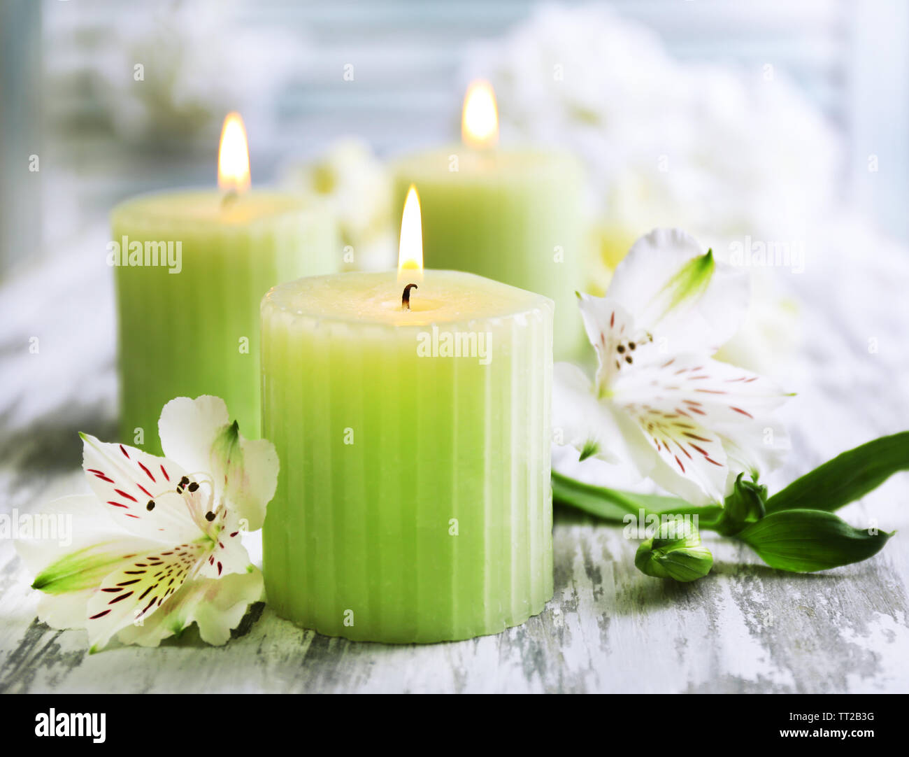Beautiful candles with flowers on wooden background Stock Photo - Alamy
