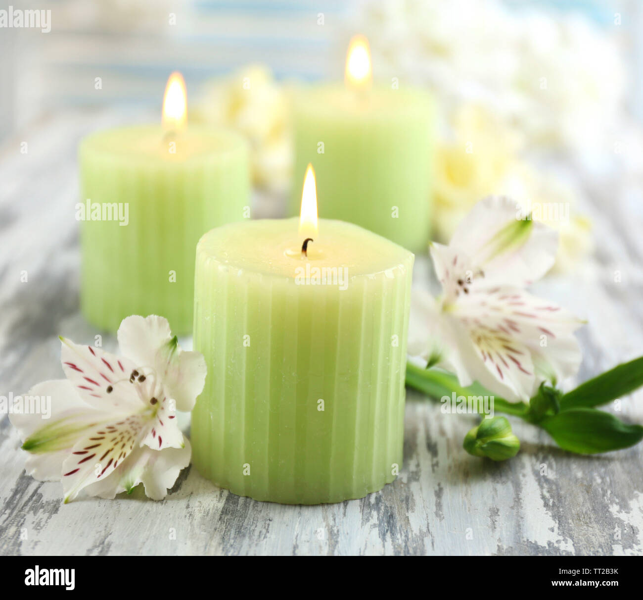 Beautiful candles with flowers on wooden background Stock Photo - Alamy