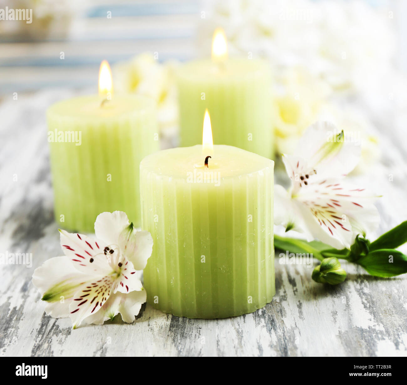 Beautiful candles with flowers on wooden background Stock Photo - Alamy