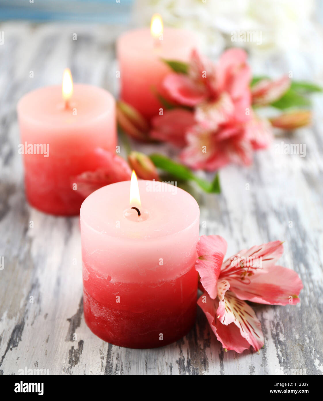 Beautiful candles with flowers on wooden background Stock Photo - Alamy
