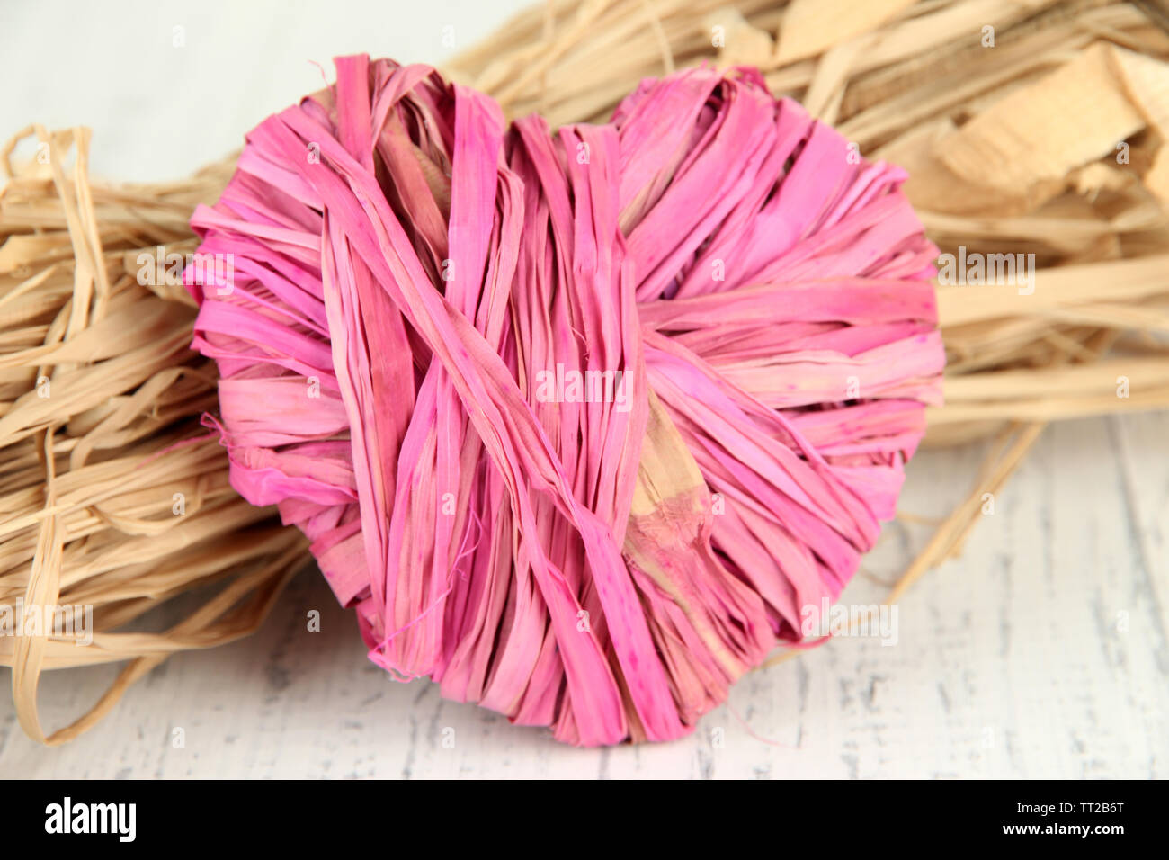 Decorative straw for hand made and heart of straw, on wooden background ...