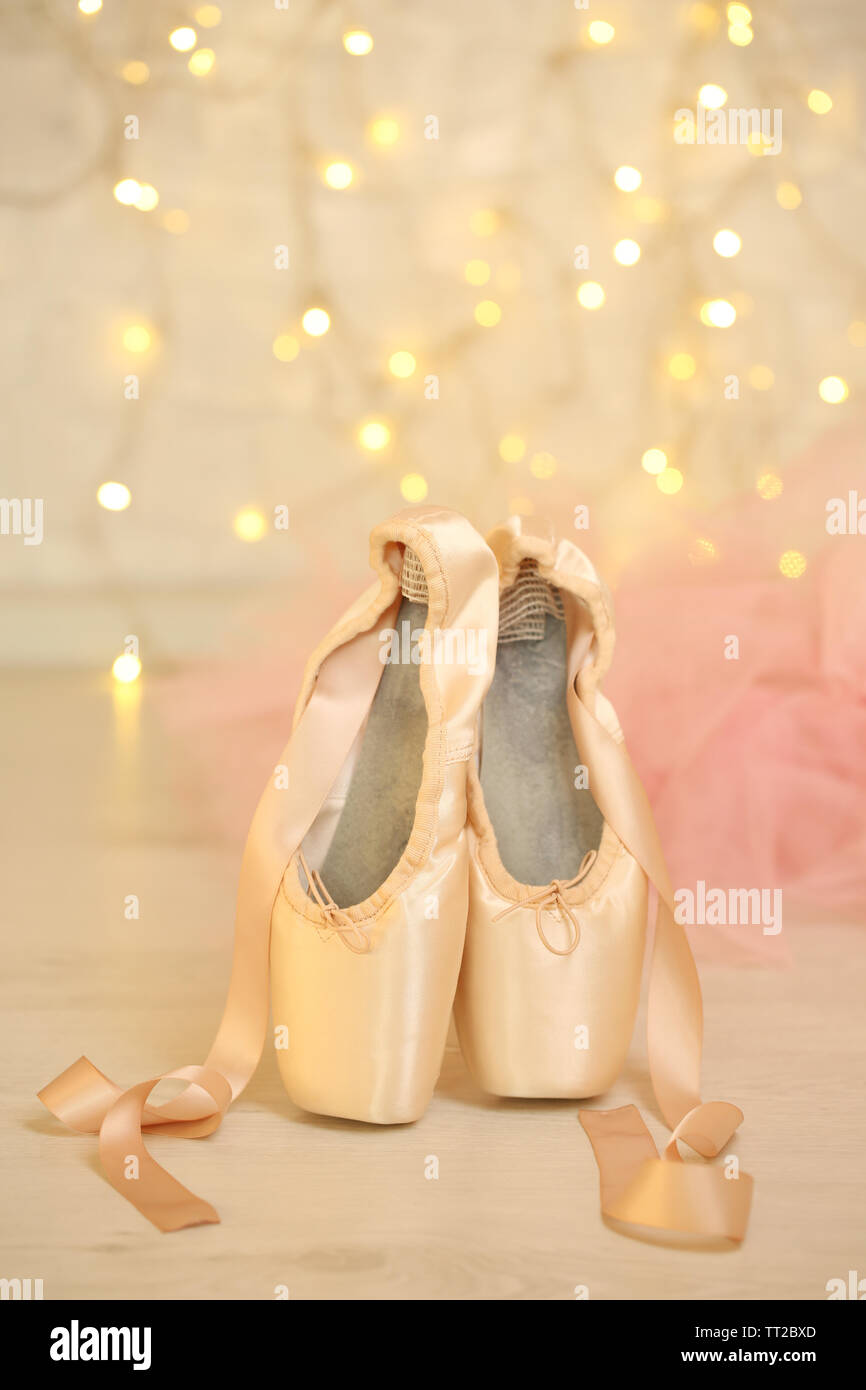 Ballet pointe shoes on floor on bokeh background Stock Photo - Alamy