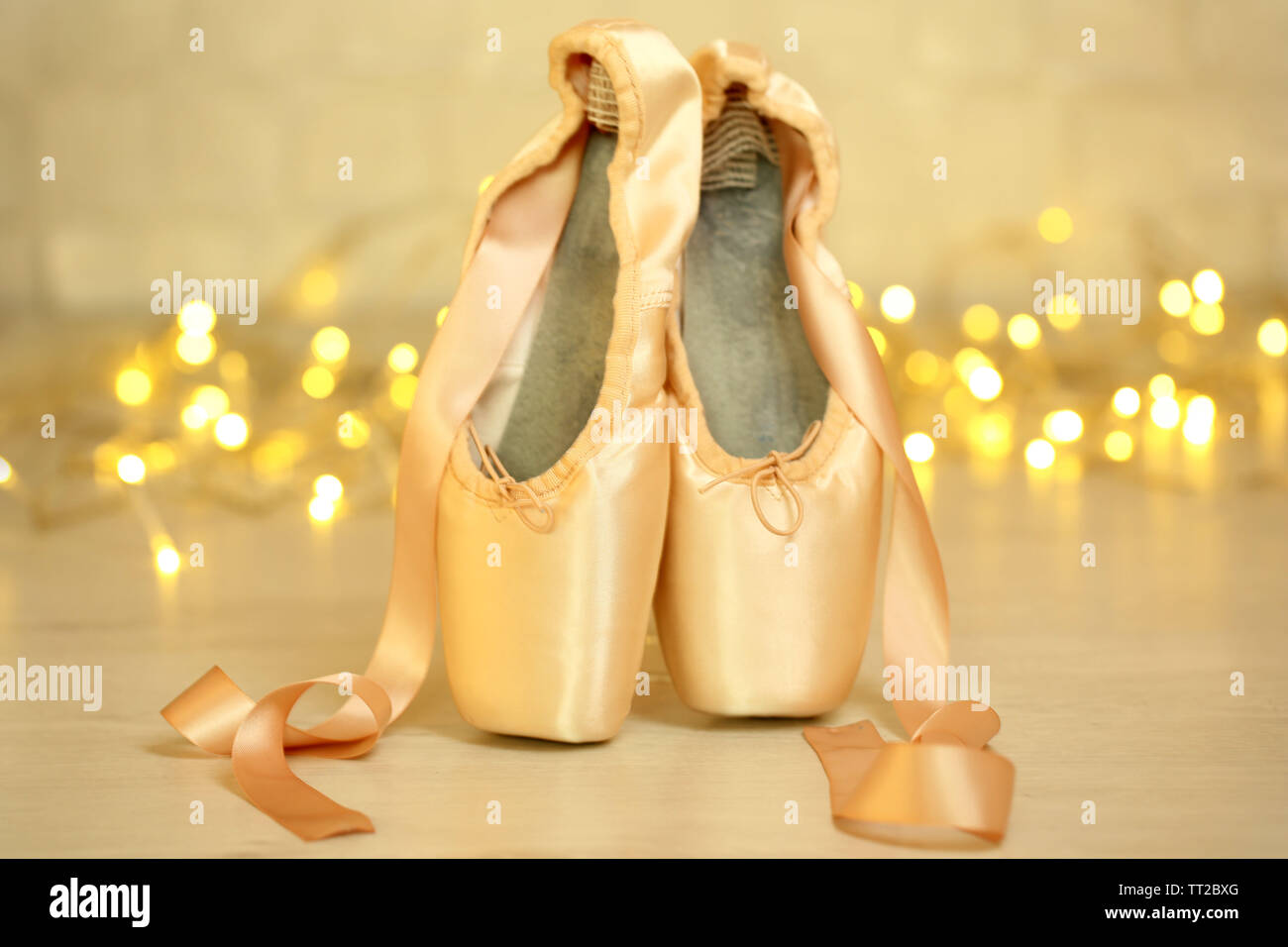 Ballet pointe shoes on floor on bokeh background Stock Photo - Alamy