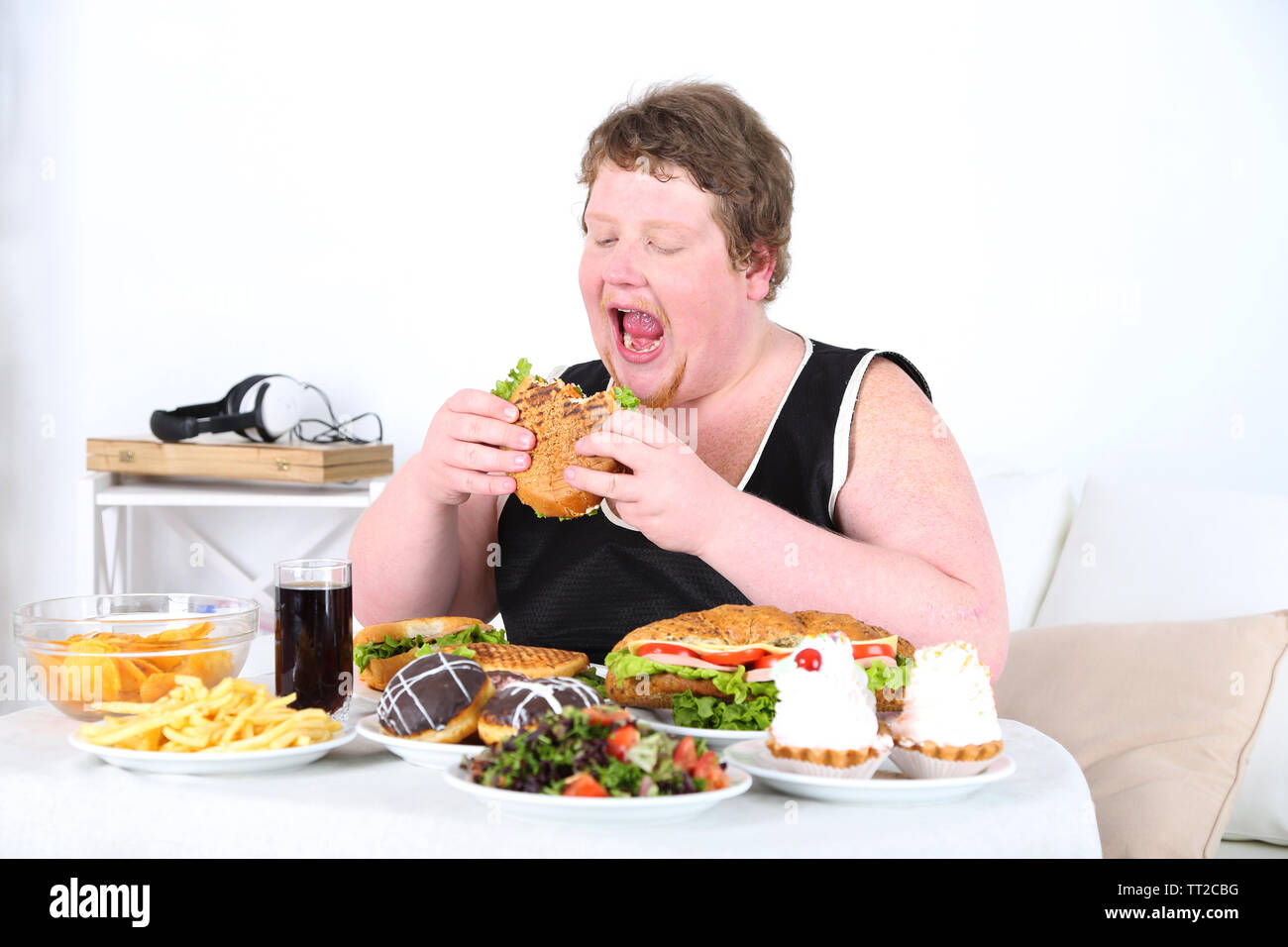 Fat Man Eating A Lot Of Unhealthy Food On Home Interior Background Stock Photo Alamy fat-man-eating-a-lot-of-unhealthy-food-on-home-interior-background-stock-photo-alamy