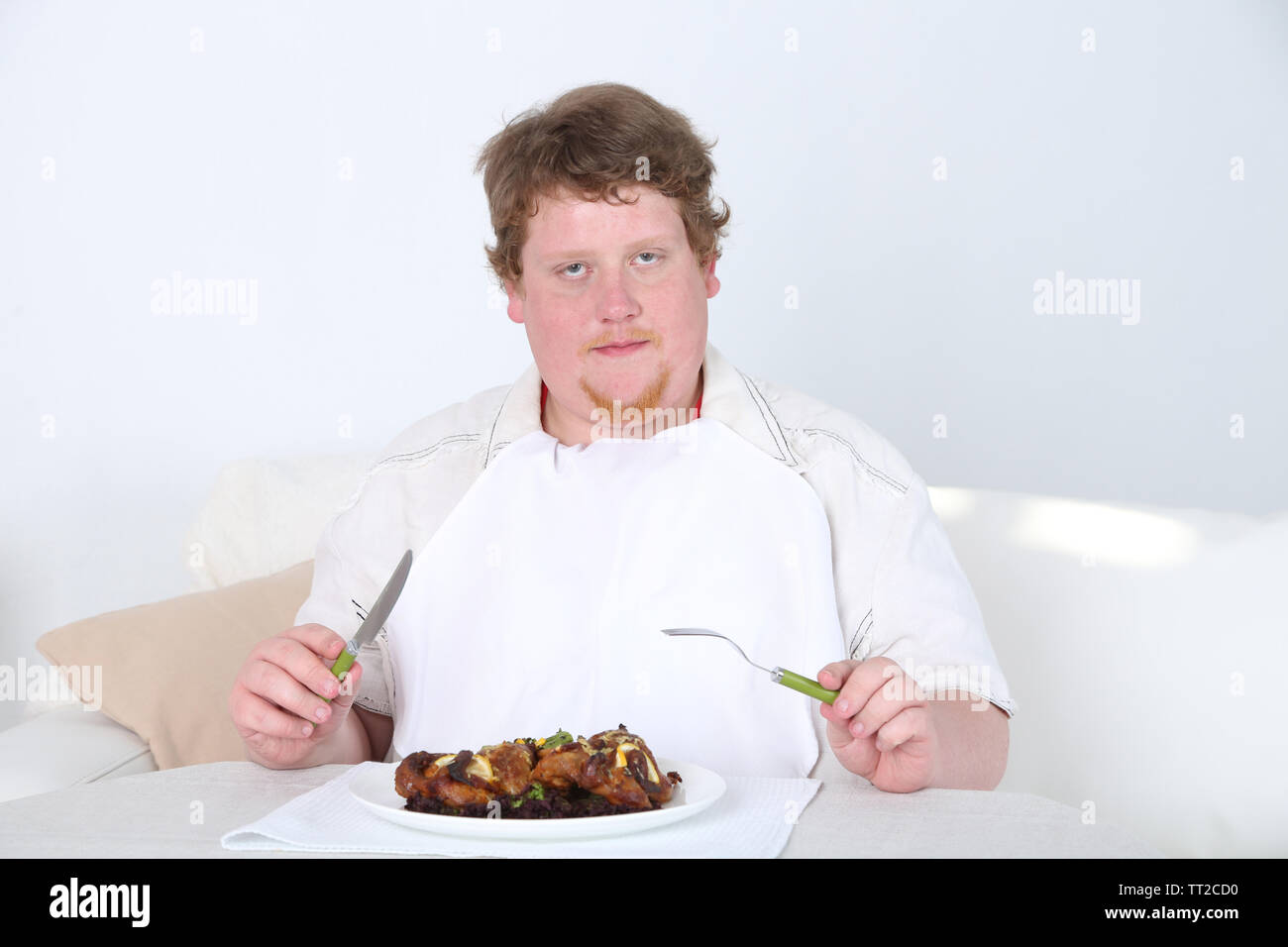 Tasty lunch for fat man, on home interior background Stock Photo - Alamy