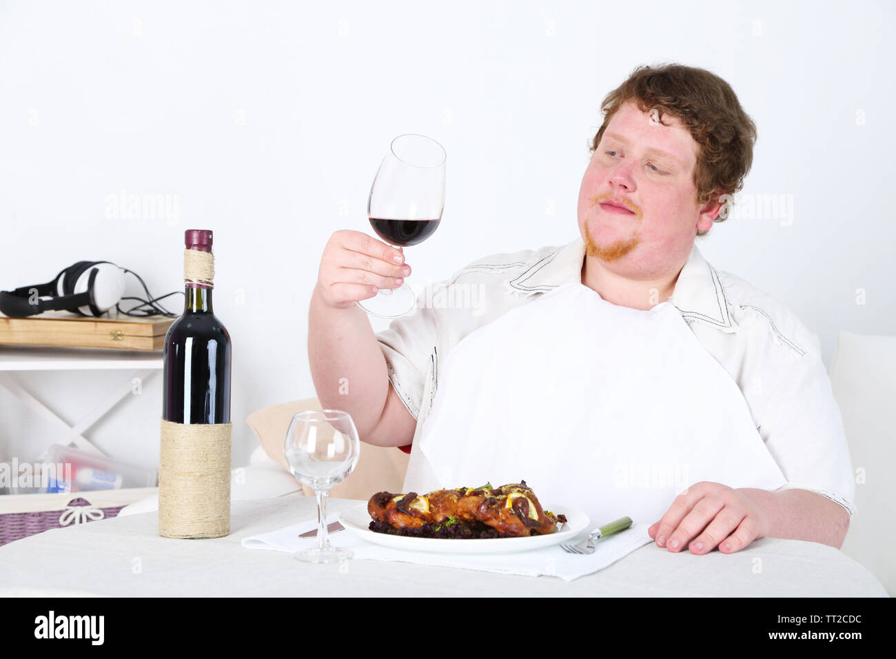 Tasty lunch for fat man, on home interior background Stock Photo - Alamy