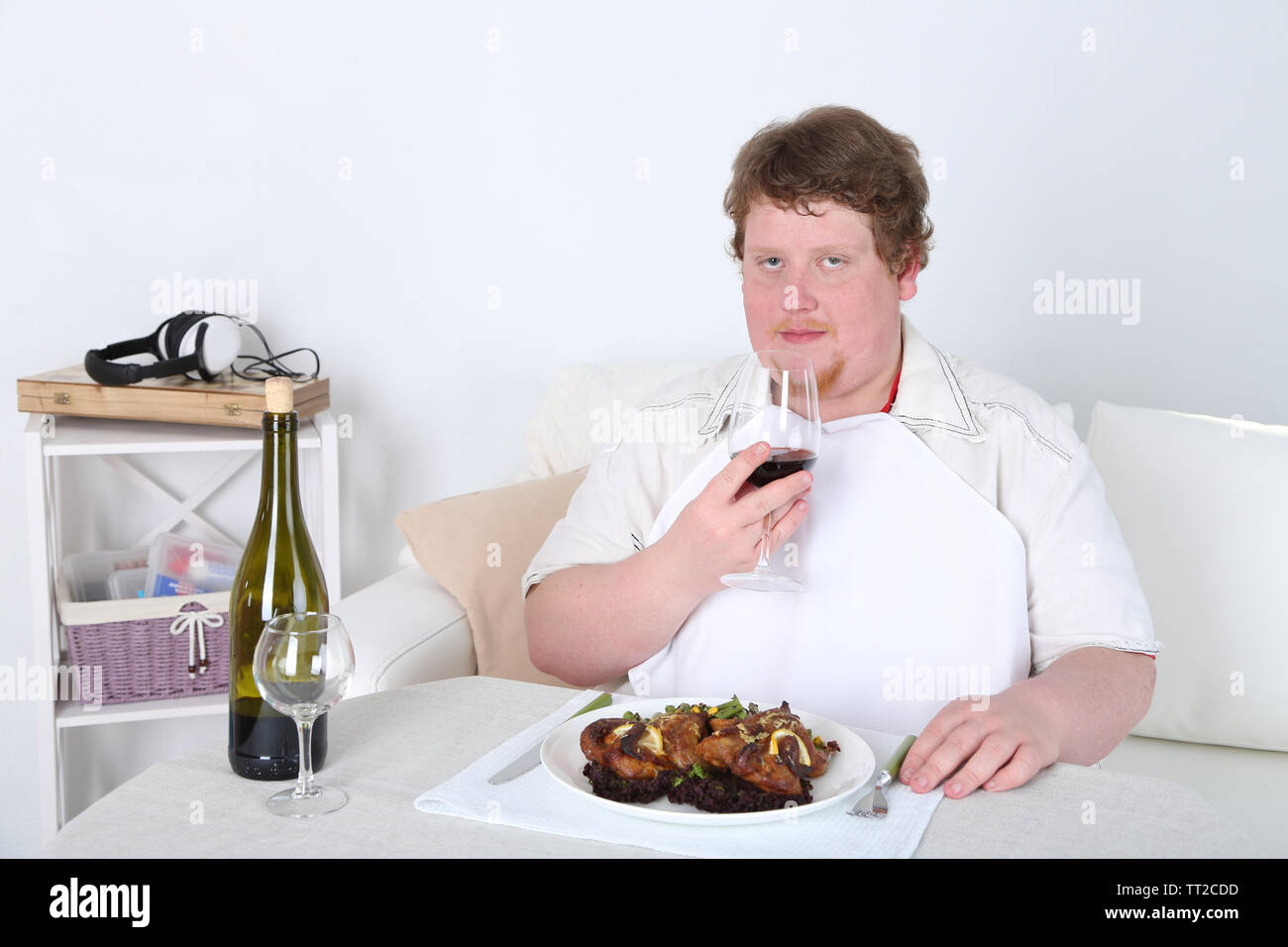 Tasty lunch for fat man, on home interior background Stock Photo - Alamy