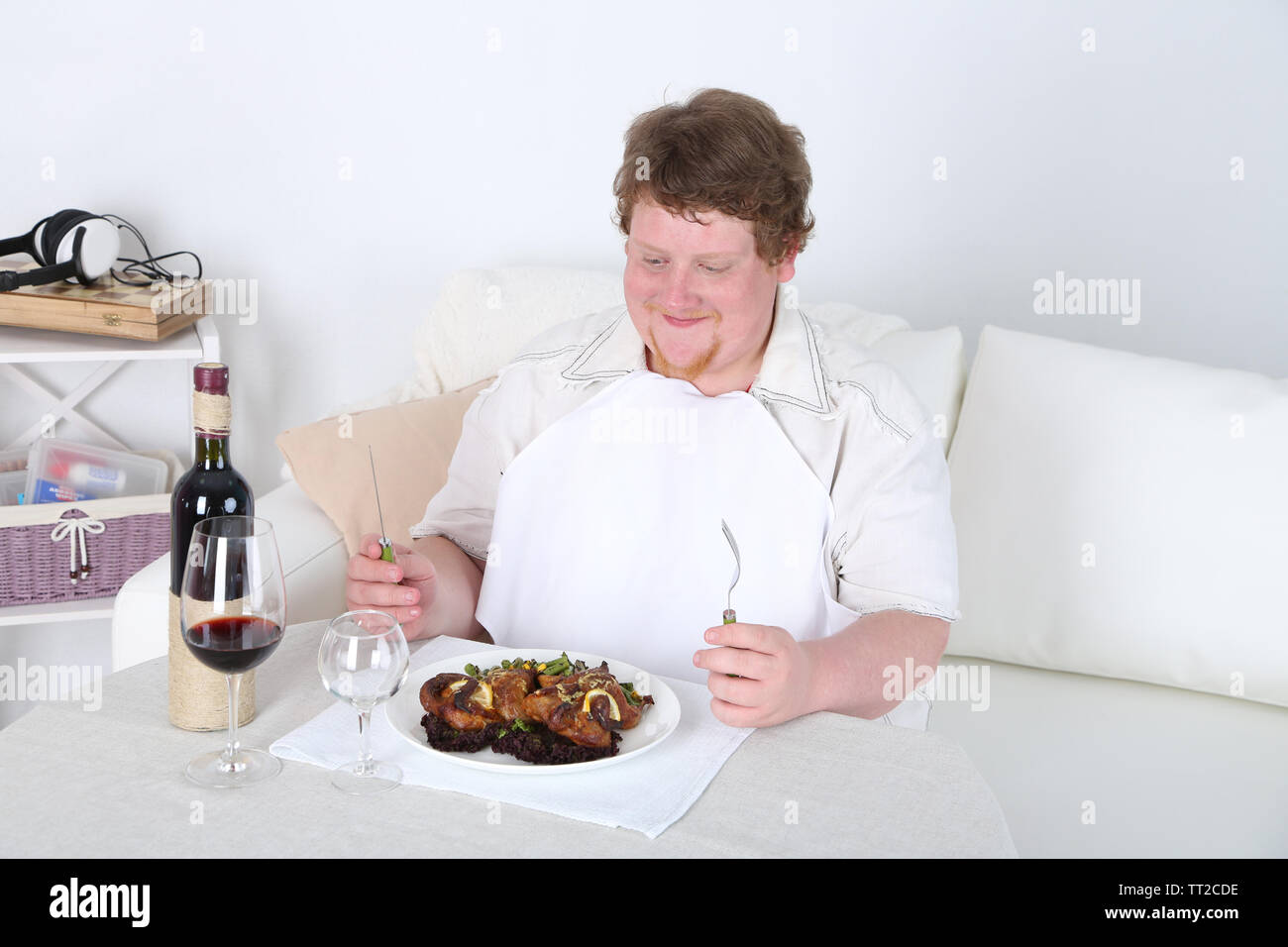 Tasty lunch for fat man, on home interior background Stock Photo - Alamy